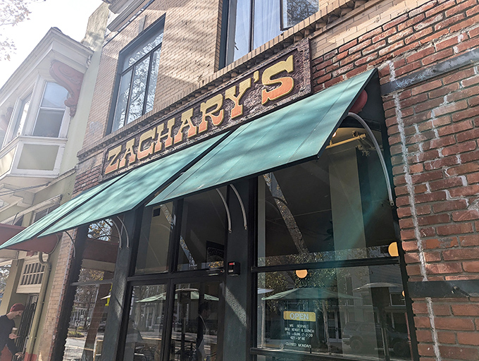 The iconic brick facade of Zachary's with its forest green awnings stands as a beacon for breakfast lovers in downtown Santa Cruz.