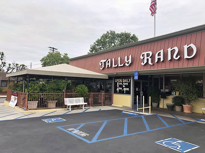 The American flag waves proudly above Tallyrand's classic red and cream exterior, where white benches await hungry patrons like front-row seats to breakfast nirvana.