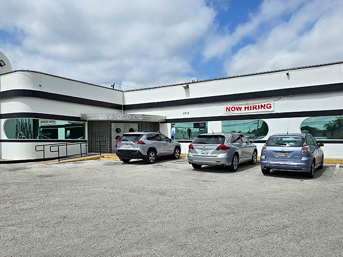 The unassuming white exterior of 410 Diner stands like a time capsule of Americana, promising comfort food treasures within those curved retro windows.