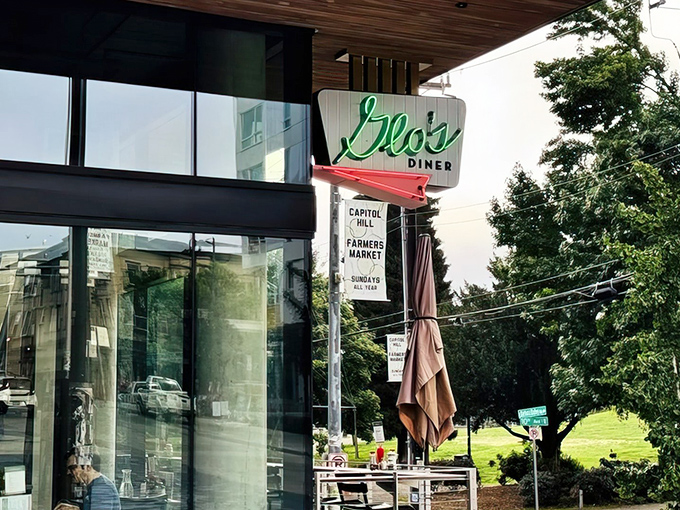 Glo's iconic green neon sign welcomes hungry patrons to their newer Capitol Hill location, where breakfast dreams come true regardless of Seattle's notorious weather.