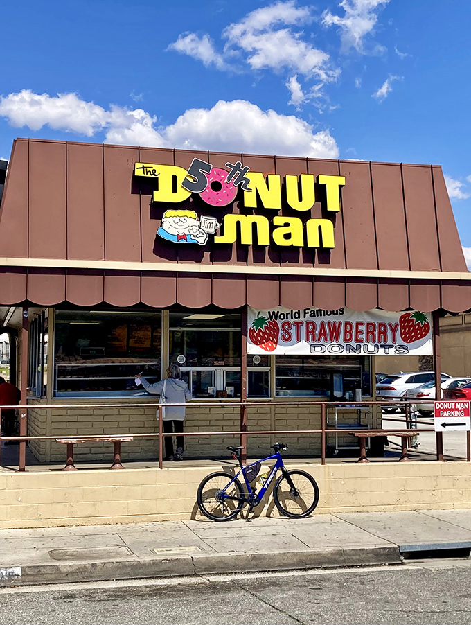 The iconic brown building with its cheerful yellow sign stands proudly on Route 66, beckoning donut lovers from near and far.