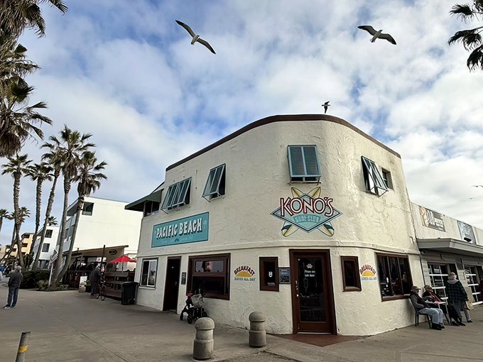 Seagulls soar above Kono's iconic white building, as if they too are waiting for those legendary breakfast potatoes. Pacific Beach's morning landmark beckons hungry souls.