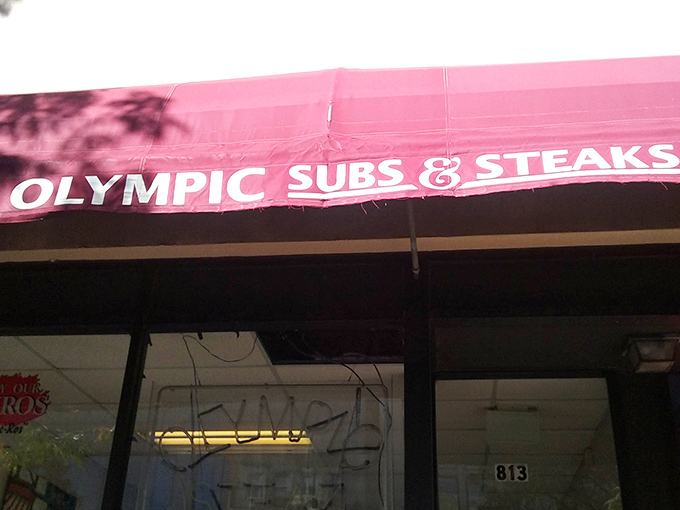 The iconic red awning of Olympic Subs & Steaks stands as a beacon of hope for the hungry on North Market Street. No frills, just sandwich thrills.