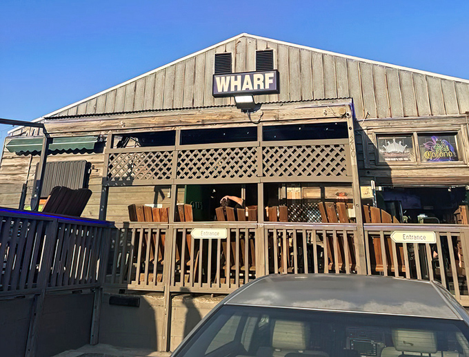The weathered wooden exterior of The Wharf stands like a salty sea captain, promising authentic Florida seafood treasures within its humble walls.