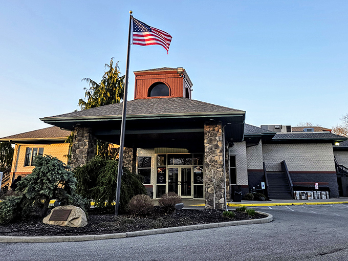 A patriotic welcome awaits at this stone-clad entrance, where the American flag stands as proudly as the reputation of what's cooking inside.