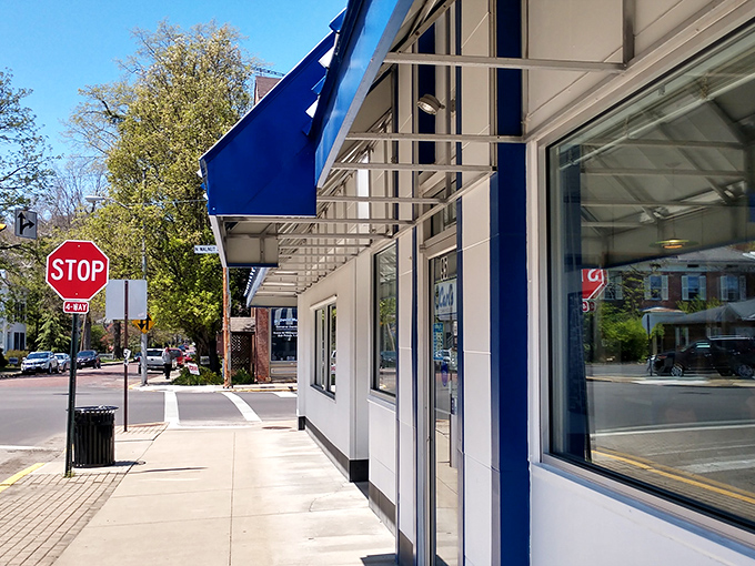 That iconic blue and white striped awning isn't just eye-catching&mdash;it's a time portal to when diners were the heart of American towns.
