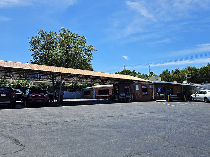The parking lot view reveals the restaurant's practical charm - no valet parking here, just honest food waiting under that utilitarian overhang.