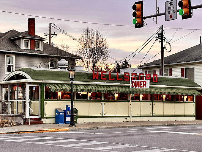 The Wellsboro Diner stands proudly on Main Street, its vintage railcar design and iconic red lettering a beacon for hungry travelers seeking authentic Americana.
