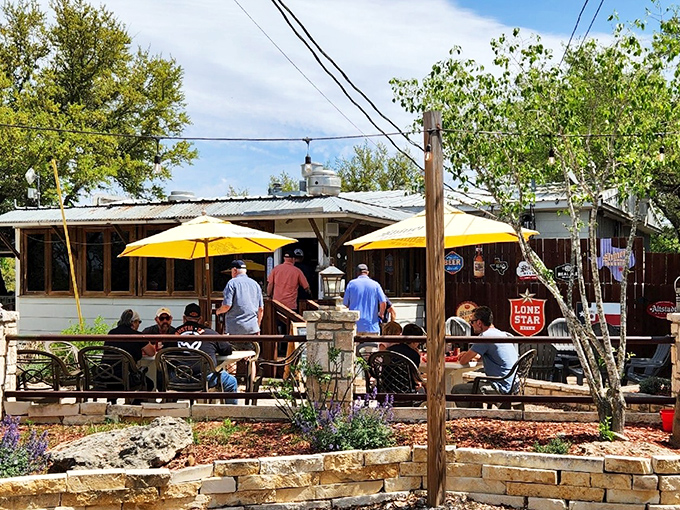 The promised land of patty perfection beckons with its umbrellas and wooden deck, where pilgrims gather for burger enlightenment in the Texas Hill Country.