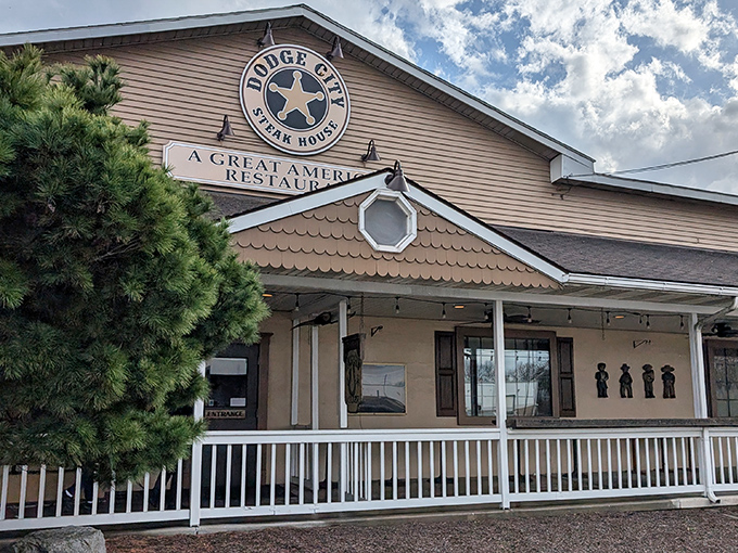 A closer look at the facade reveals the restaurant's commitment to its "Great American" identity, complete with cowboy silhouettes standing guard.