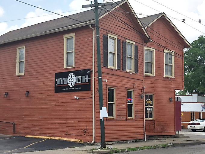 The rust-red exterior of South Park Pizza Tavern stands like a culinary sentinel in Dayton, promising comfort food without pretension or apology.