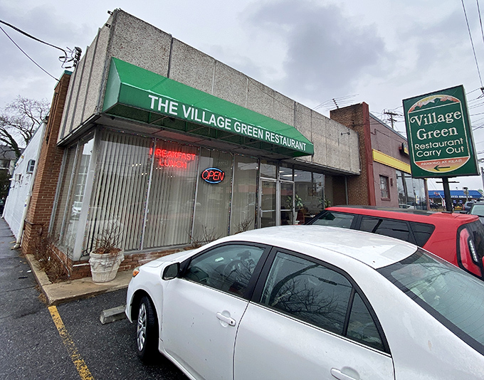 The unassuming exterior of Village Green Restaurant proves that culinary treasures often hide behind modest facades. Like finding Sinatra singing at your local VFW hall.