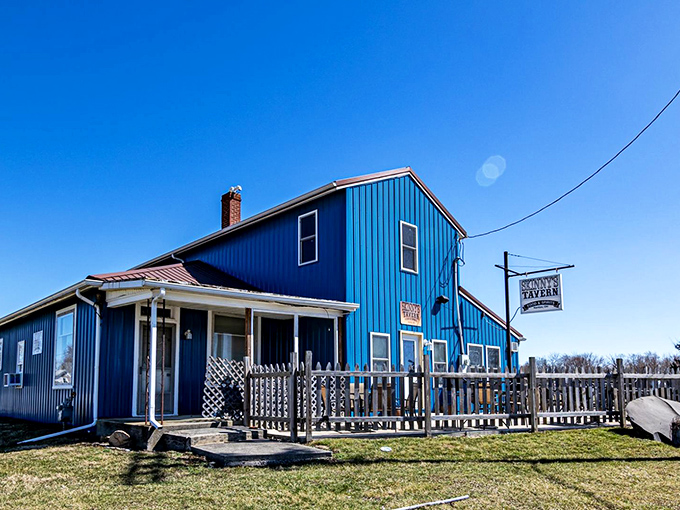 The blue building that launched a thousand cravings. Skinny's Tavern stands out against the Ohio sky like a beacon for burger enthusiasts seeking salvation from mediocre meals.