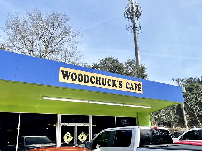 The blue and lime green exterior of Woodchuck's Caf&eacute; stands out like a cheerful beacon for hungry travelers. No fancy frills, just the promise of good eating ahead.