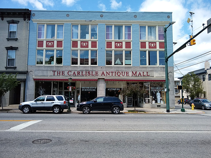 The Carlisle Antique Mall stands tall on Main Street, its vibrant fa&ccedil;ade inviting treasure hunters inside to explore decorative furniture and timeless finds.