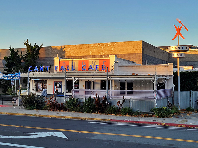 The golden hour glow on Rudy's Can't Fail Cafe feels like California sunshine bottled up in neon letters and white stucco.