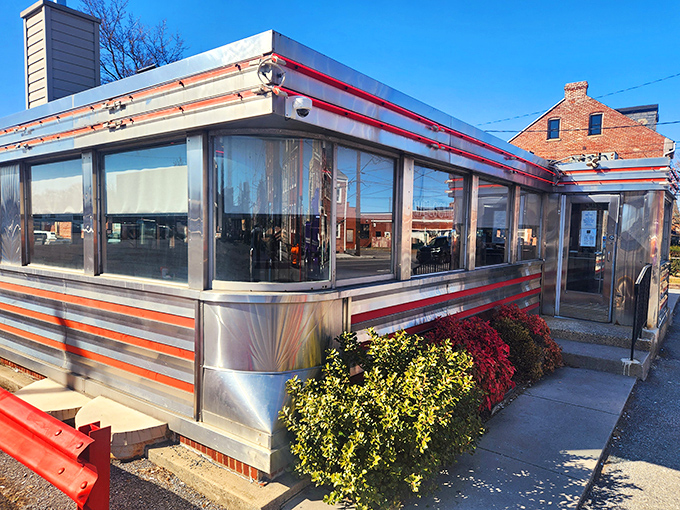 The classic stainless steel exterior of Neptune Diner gleams in the evening light, a beacon of comfort food promising homestyle cooking to hungry travelers.