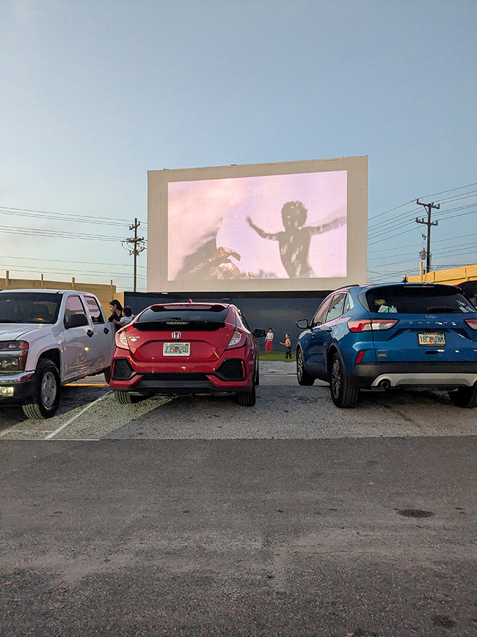 Movie magic under the stars! Cars line up at Silver Moon Drive-In as twilight transforms an ordinary screen into a portal to cinematic adventures.