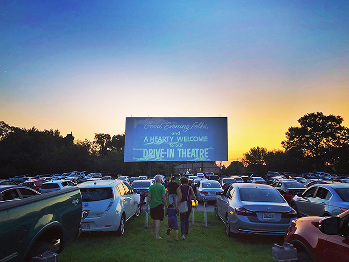 Twilight magic unfolds as families gather beneath the glow of cinema's last great communal ritual. Nothing beats watching movies under an actual sky.