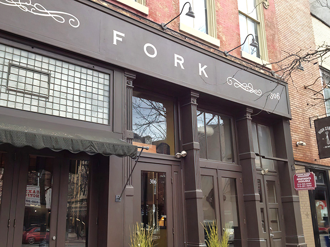Fork's understated exterior belies the culinary magic happening inside. The elegant signage and classic brick fa&ccedil;ade set the perfect stage for what's to come.