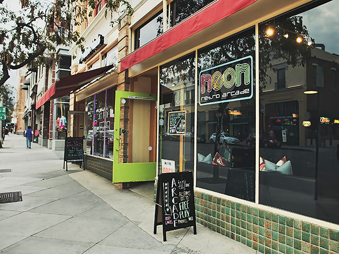 The neon glow beckons like a time portal on Pasadena's Raymond Avenue, promising digital adventures from decades past.