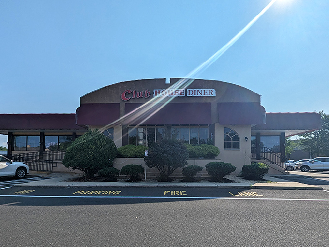 The Club House Diner stands proudly against the Pennsylvania sky, its burgundy awnings beckoning hungry travelers like a lighthouse for the breakfast-obsessed.