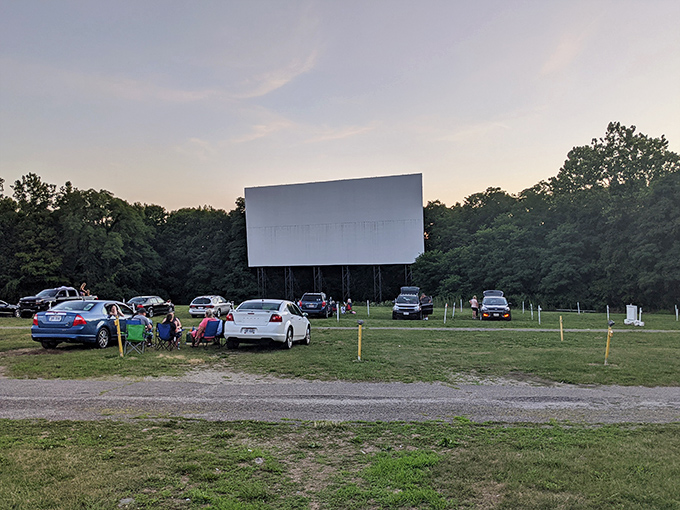 Cars lined up facing the massive white screen as dusk settles in&mdash;cinema's most perfect pairing since popcorn met butter.