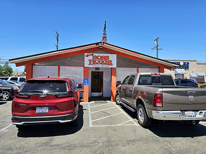 The bright orange facade of Boss Hogg's stands like a beacon of comfort food salvation in Farmersville, promising Southern hospitality in California's agricultural heartland.