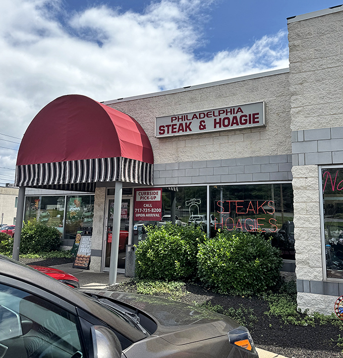 The iconic red awning of Philadelphia Steaks & Hoagies stands out like a beacon of hope for the hungry in Camp Hill. Cheesesteak salvation awaits!