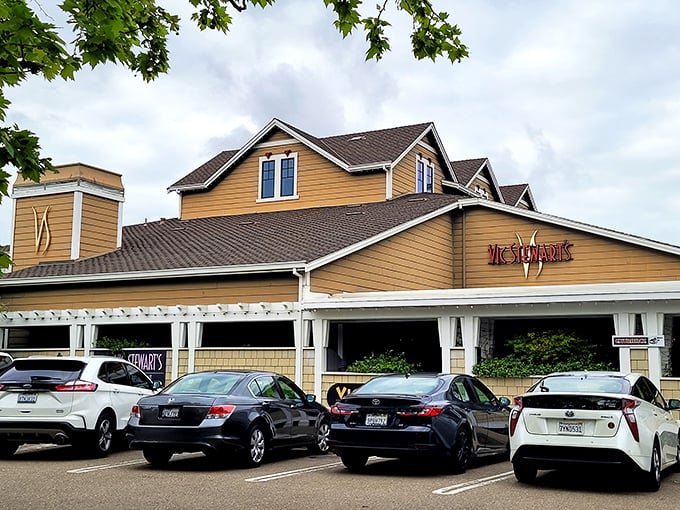 Approaching Vic Stewart's feels like discovering a secret clubhouse for steak enthusiasts. The tan exterior with white trim and ample parking suggests they're serious about accommodating hungry visitors.