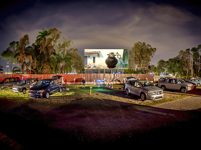 Movie magic under the stars! Cars gather beneath Florida's twilight sky as the massive screen illuminates with cinematic wonder at Ruskin Family Drive-In.