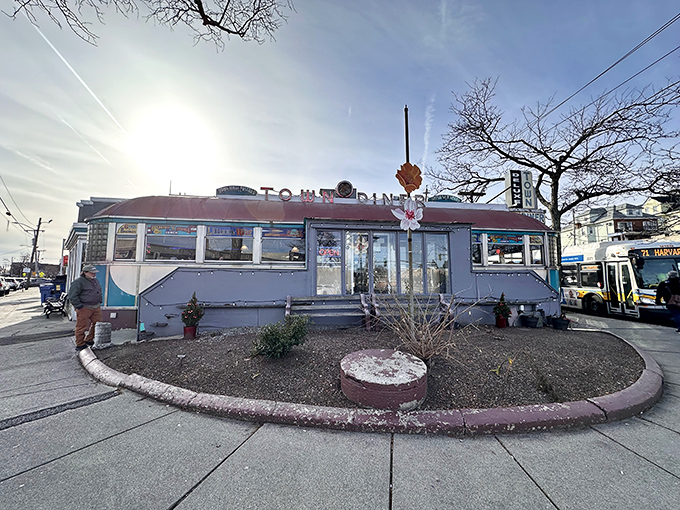 The classic stainless steel exterior of Deluxe Town Diner stands like a time capsule on Watertown's Mount Auburn Street, promising comfort food and nostalgia in equal measure.
