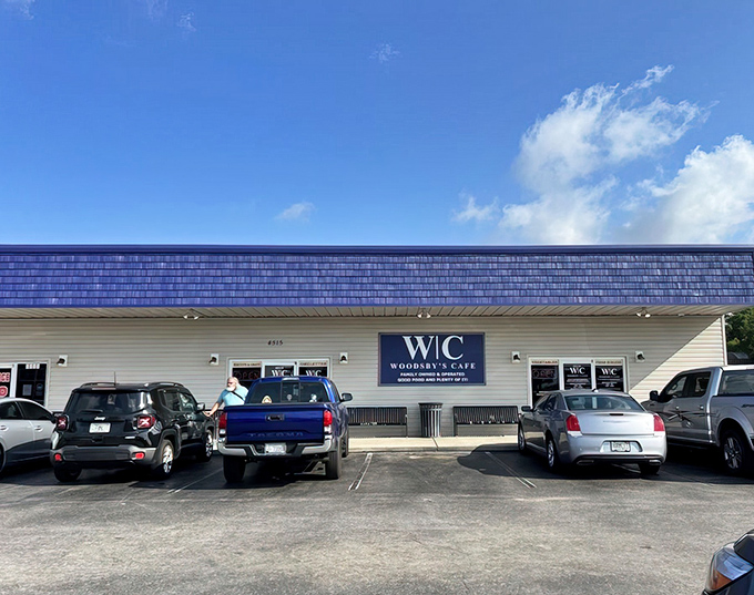 Behind this modest blue sign lies a breakfast kingdom where omelets reign supreme and coffee flows like conversation.