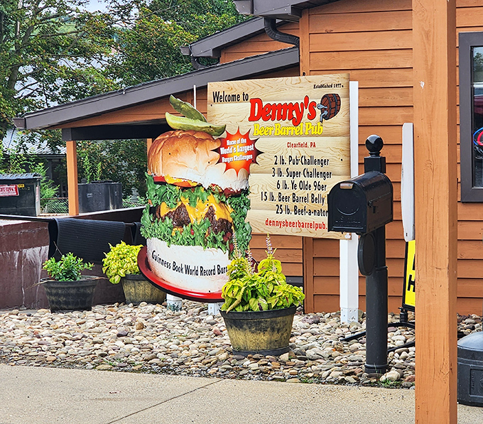 The legendary burger monument outside Denny's Beer Barrel Pub announces your arrival to burger paradise. This isn't just signage&mdash;it's a warning of the delicious challenges that await inside.