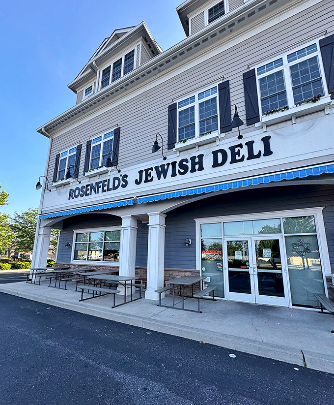 The classic blue awning and gray clapboard exterior of Rosenfeld's Jewish Deli stands as a beacon of comfort food in Rehoboth Beach.