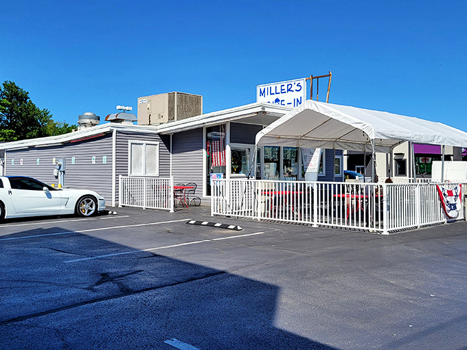 The blue-gray exterior of Miller's Drive-In stands like a humble temple to comfort food, its white fence and awning welcoming hungry pilgrims from across Ohio.