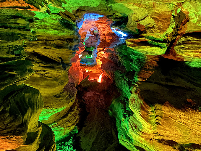 Nature's light show on full display! The vibrant illumination transforms these ancient sandstone formations into a psychedelic underground dreamscape that feels straight out of a sci-fi film.