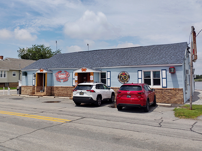 The unassuming blue exterior of Sambo's Tavern stands like a beacon for crab lovers, promising seafood treasures within its humble walls.