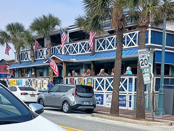 Flagler Tavern's iconic blue and white facade welcomes seafood lovers with swaying palms and a breezy wraparound porch perfect for people-watching.