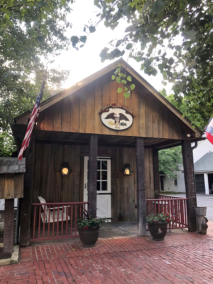 The rustic wooden exterior of Spread Eagle Tavern welcomes you like an old friend who's been waiting since the 1800s for your arrival.
