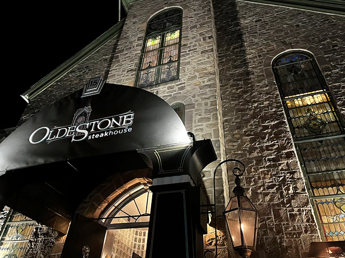 The stone facade of Oldestone glows with promise at night, its elegant awning beckoning hungry travelers like a lighthouse for carnivores.
