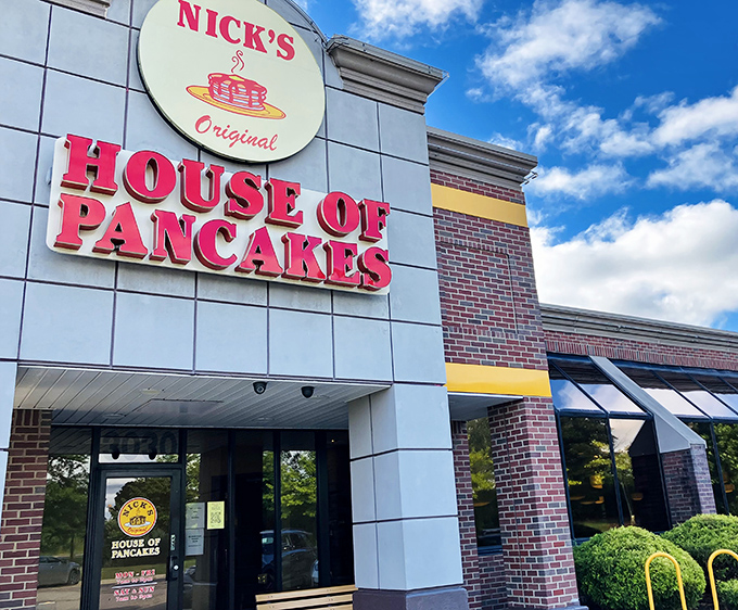 The iconic red signage of Nick's Original House of Pancakes stands out against Michigan's blue sky &ndash; a beacon for breakfast enthusiasts seeking morning salvation.