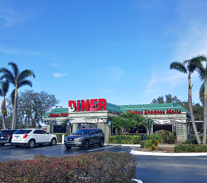 The classic stainless steel exterior of Sebring Diner gleams under the Florida sun like a time machine disguised as a restaurant. Those palm trees aren't just decoration—they're sentinels guarding a temple of comfort food.
