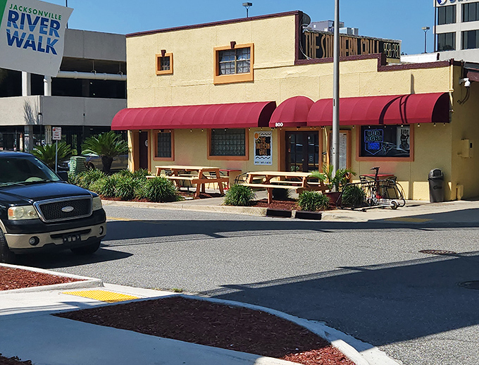 The unassuming yellow exterior with red awnings is like finding a treasure map where X marks the sandwich spot.
