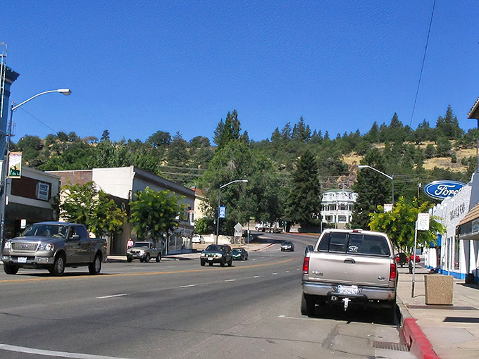 Main Street Susanville stretches toward mountain vistas, where historic brick buildings and blue skies create California's most affordable postcard setting.