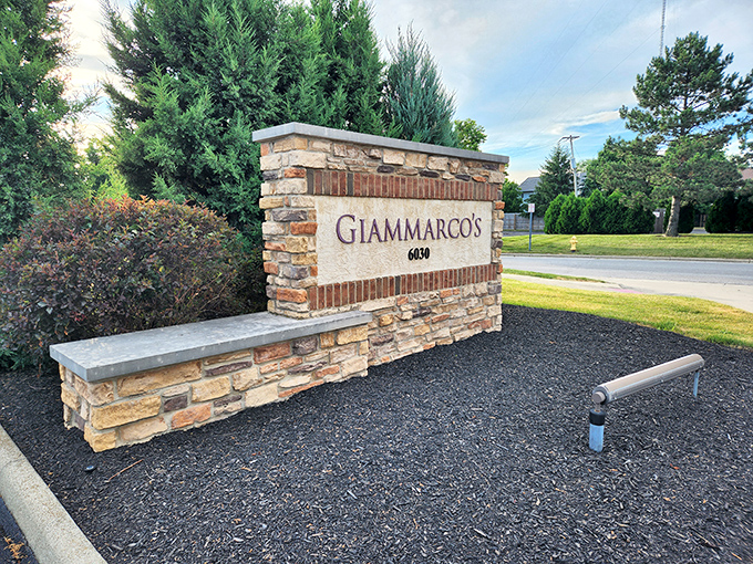 The welcoming stone entrance sign to Giammarco's stands like a sentinel of good taste, promising Italian delights just beyond its stucco walls.