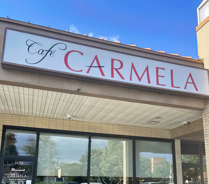 The iconic red lettering of Cafe Carmela beckons like a lighthouse for the hungry. Philadelphia's hidden gem awaits your discovery.