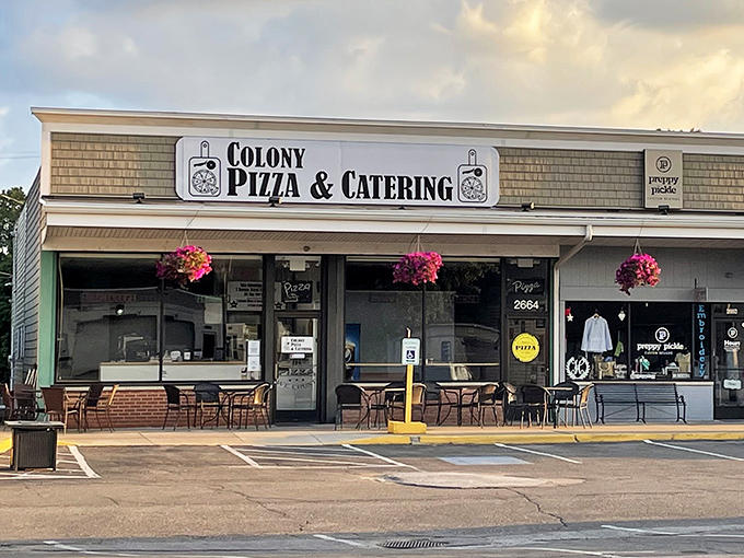 The unassuming storefront of Colony Pizza, where culinary magic happens behind those hanging flower baskets. Pizza paradise doesn't need neon signs.