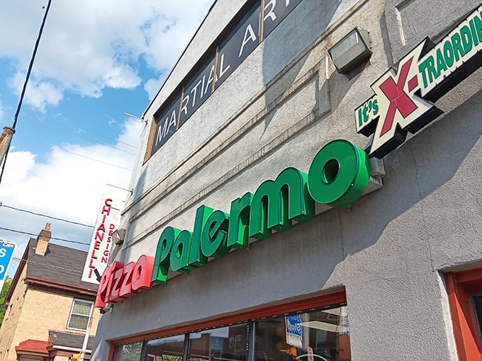 The unassuming storefront of Pizza Palermo, where culinary magic hides behind modest red and green signage. Pittsburgh's best-kept pizza secret sits quietly on Centre Avenue.