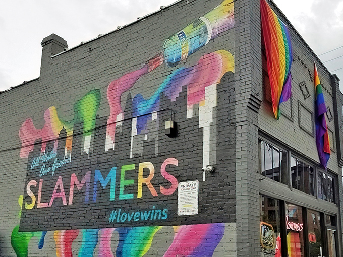 Slammers' exterior mural announces its inclusive spirit with a splash of rainbow colors and the hopeful hashtag #lovewins adorning its brick facade.